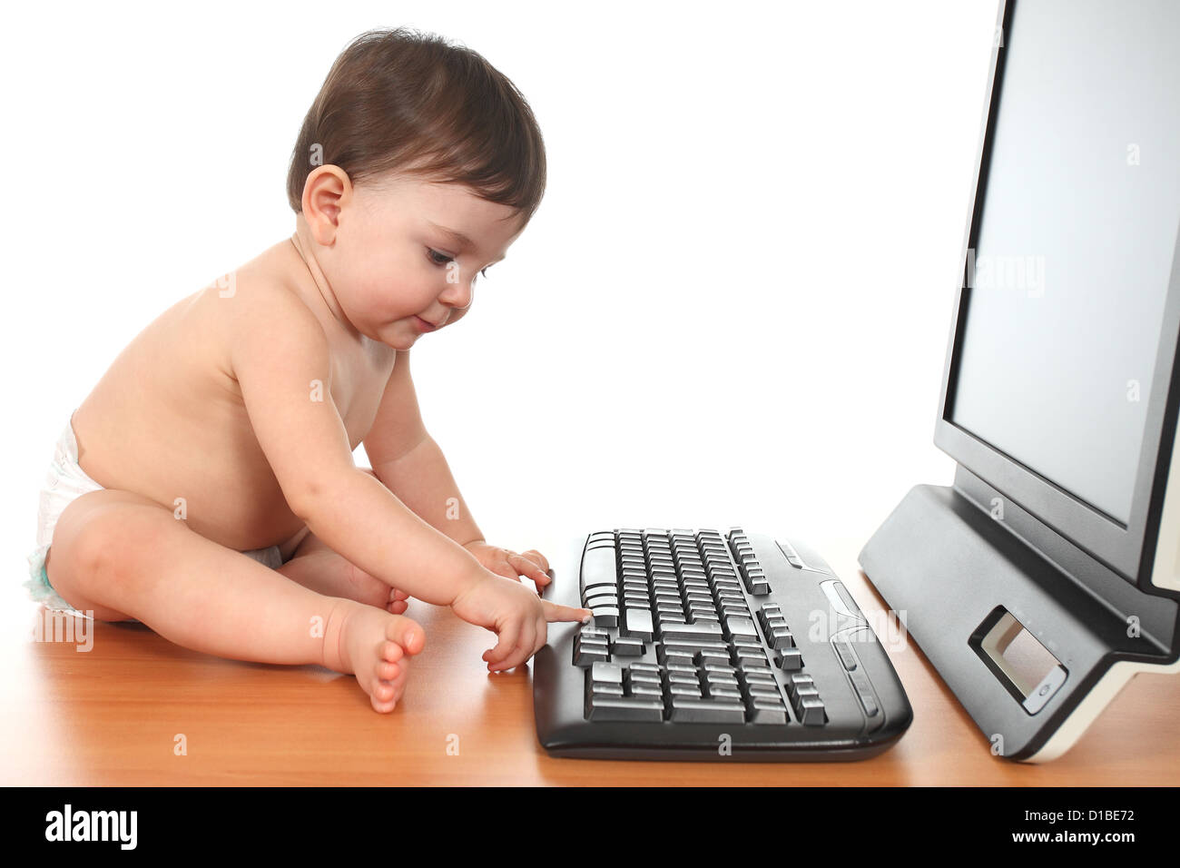 Baby typing on a computer keyboard in a white isolated background Stock ...