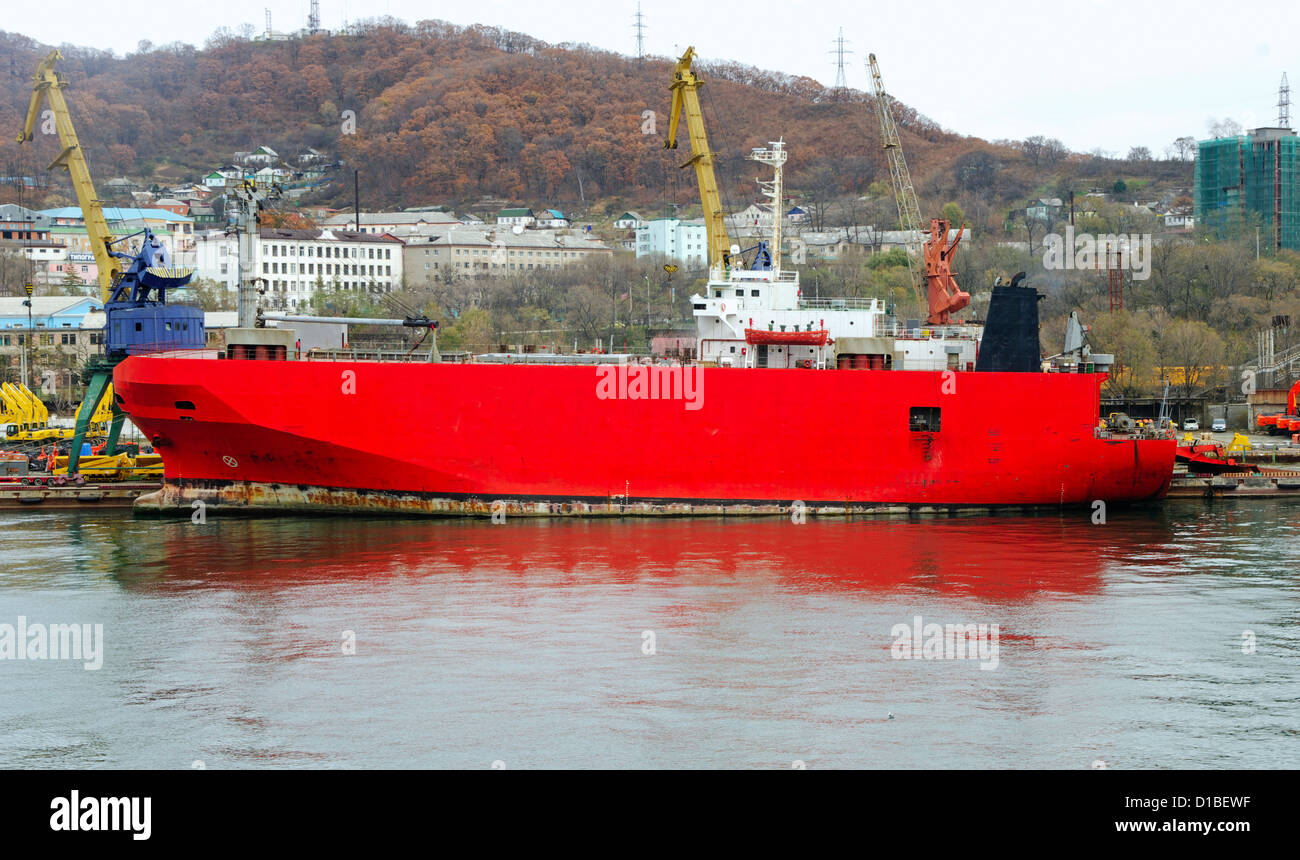 Ro-ro freight ship under unloading construction heavy equipment at the ...