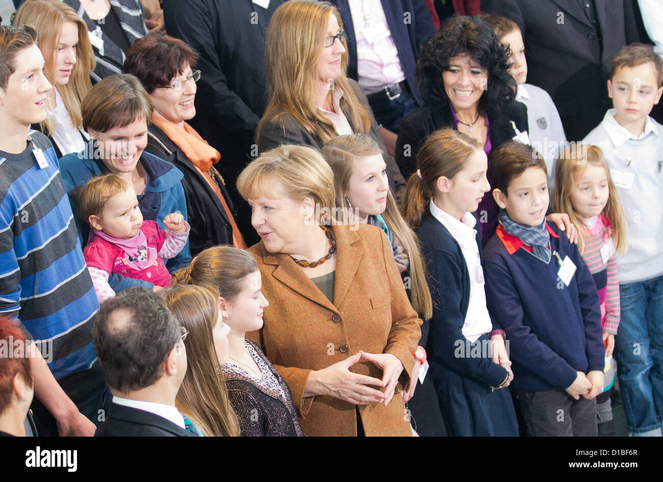 German Chancellor Merkel stands between relatives of German soldiers ...