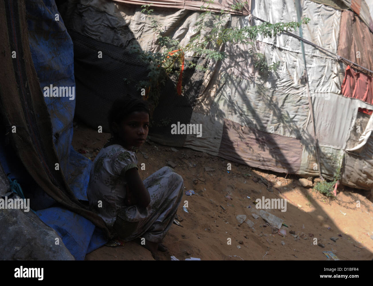 Naika sits in front of the hut of her family in a slum in Jaipur, India ...