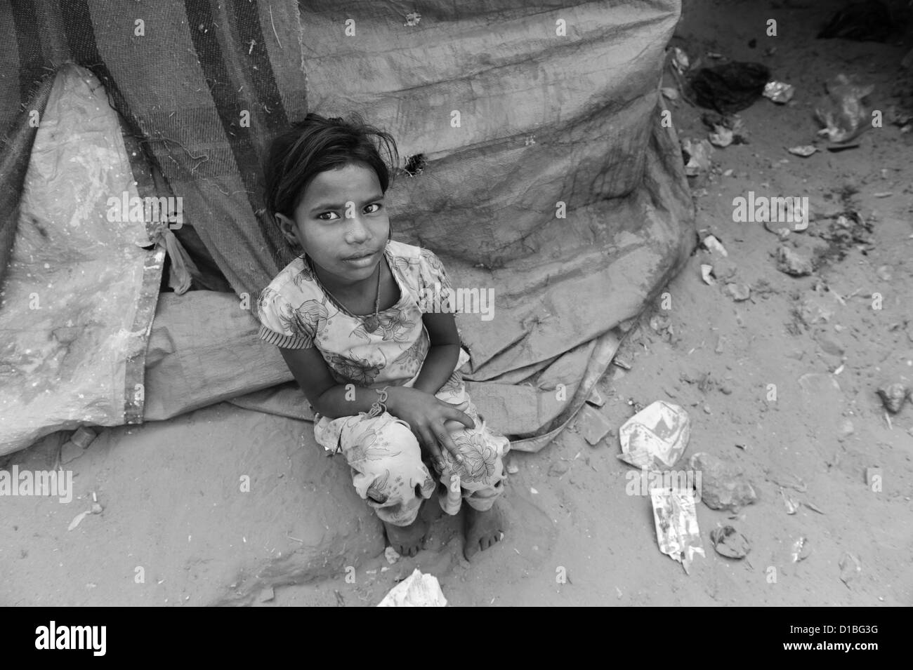 Naika sits in front of the hut of her family in a slum in Jaipur, India ...