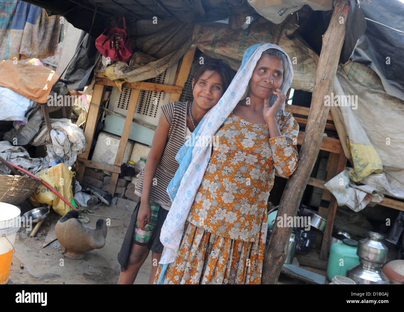 Sri and her grandmother Bahar are pictured in front of their hut in a ...