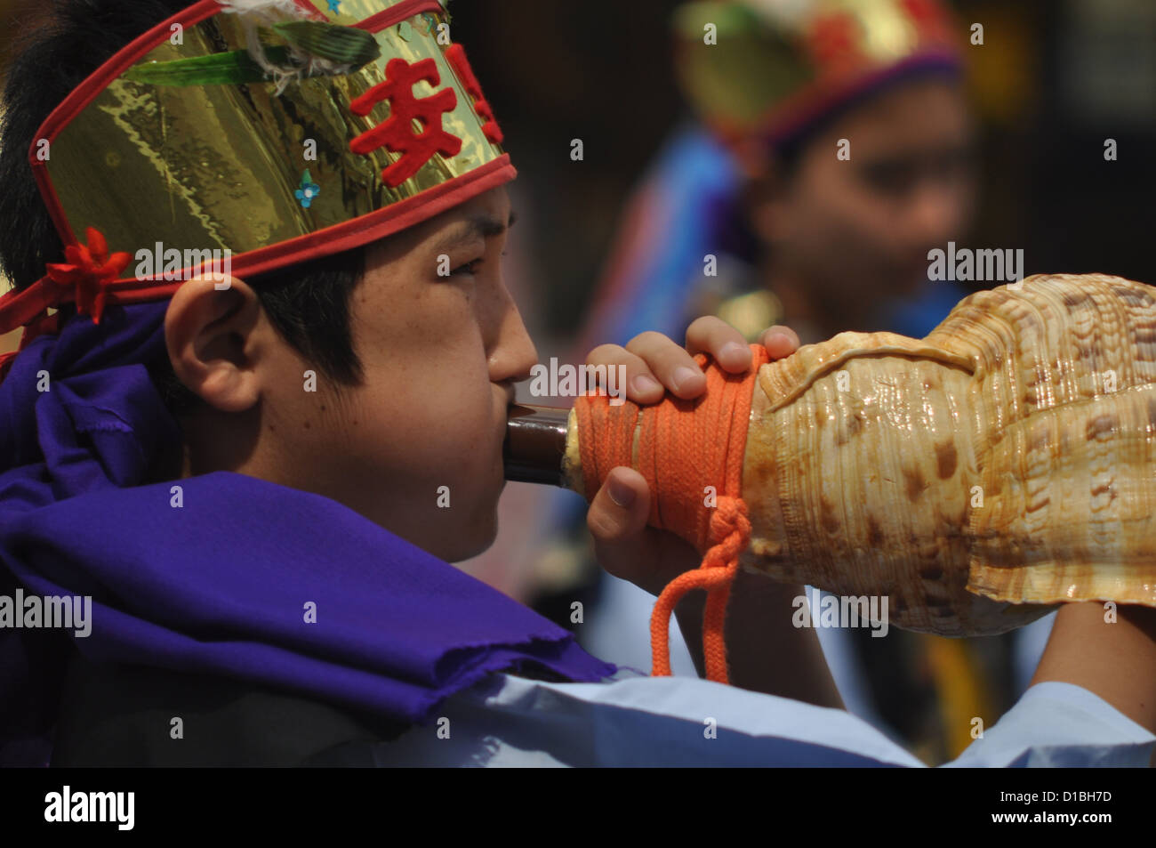 Naha (Okinawa, Japan), boy blowing into a shell during the Naha ...