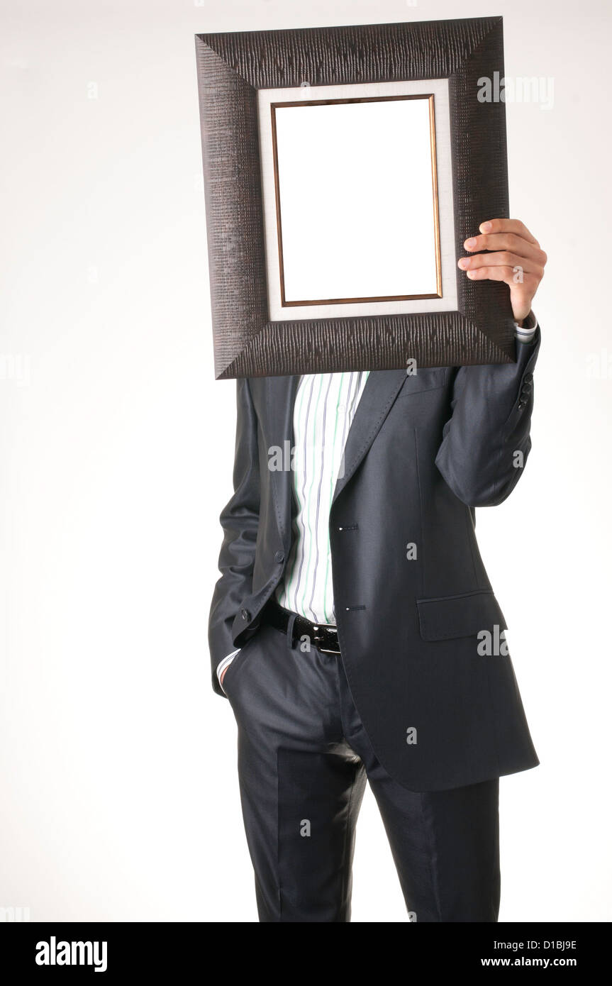 Businessman holding frame Stock Photo - Alamy