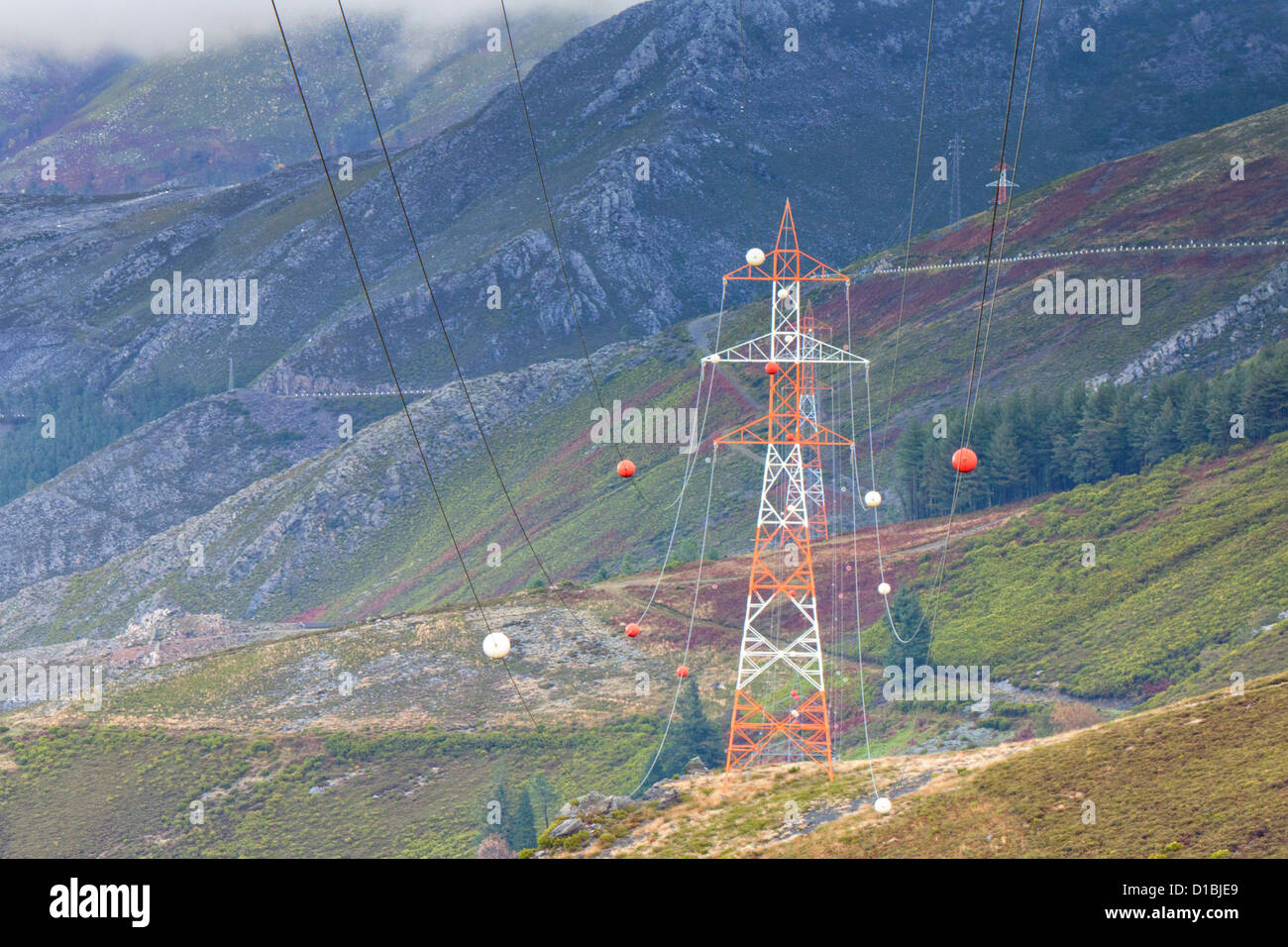 View of electricity tower and cables in the mountains Stock Photo - Alamy