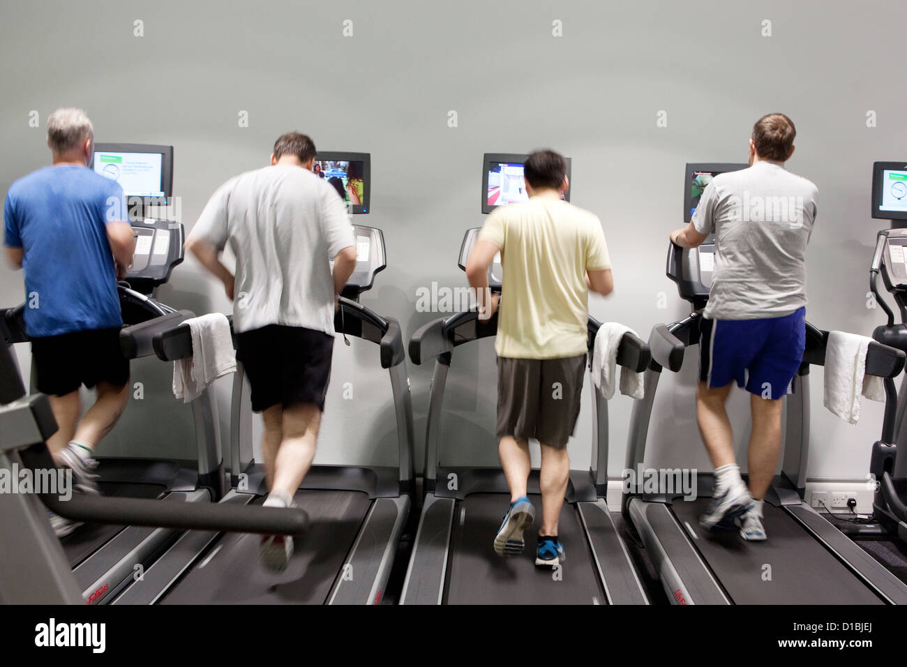 Middle aged men on running machines Stock Photo - Alamy