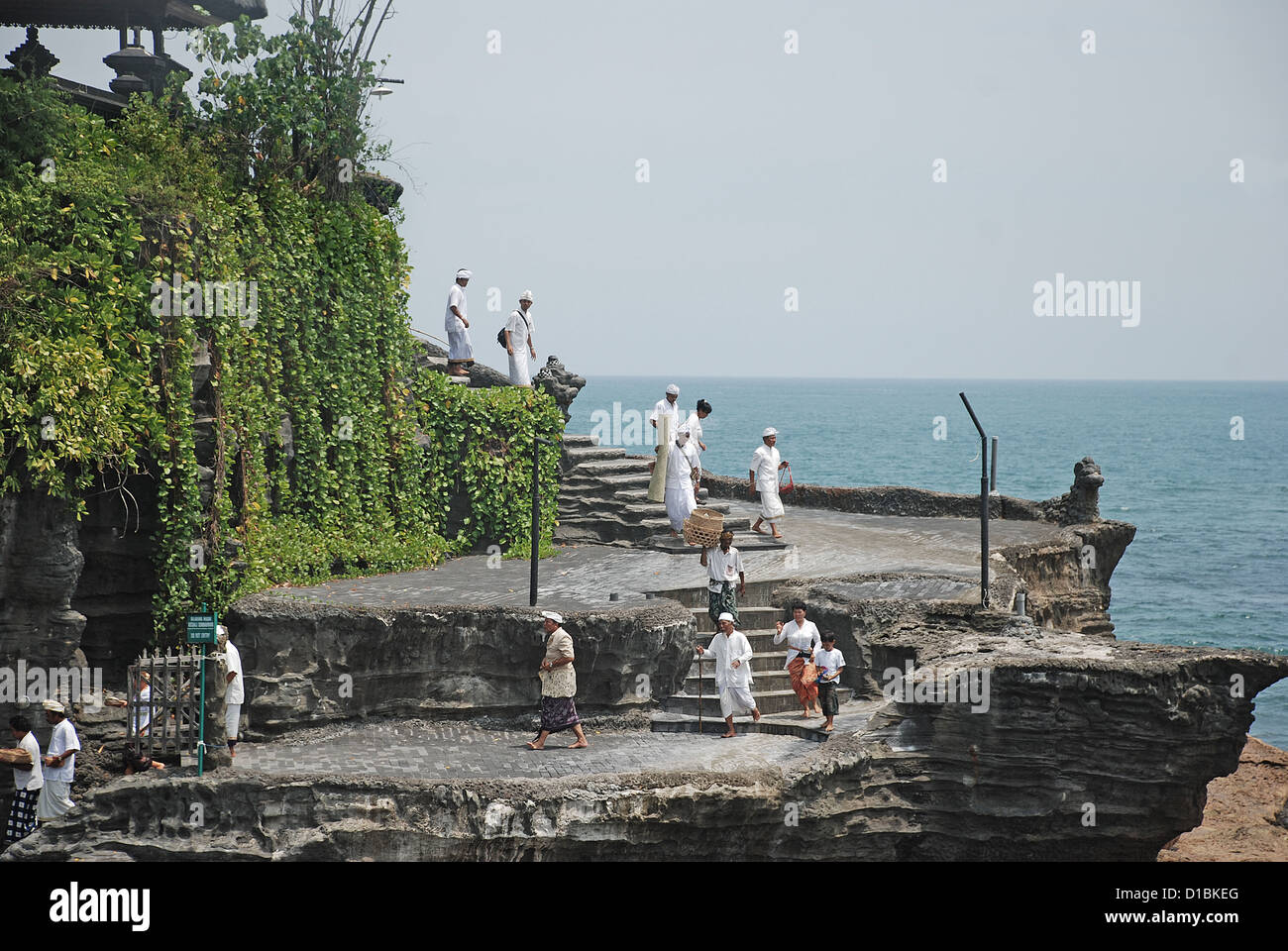 Prayers during Hindu ceremony at pilgrimage temple Pura Tanah Lot, Bali ...