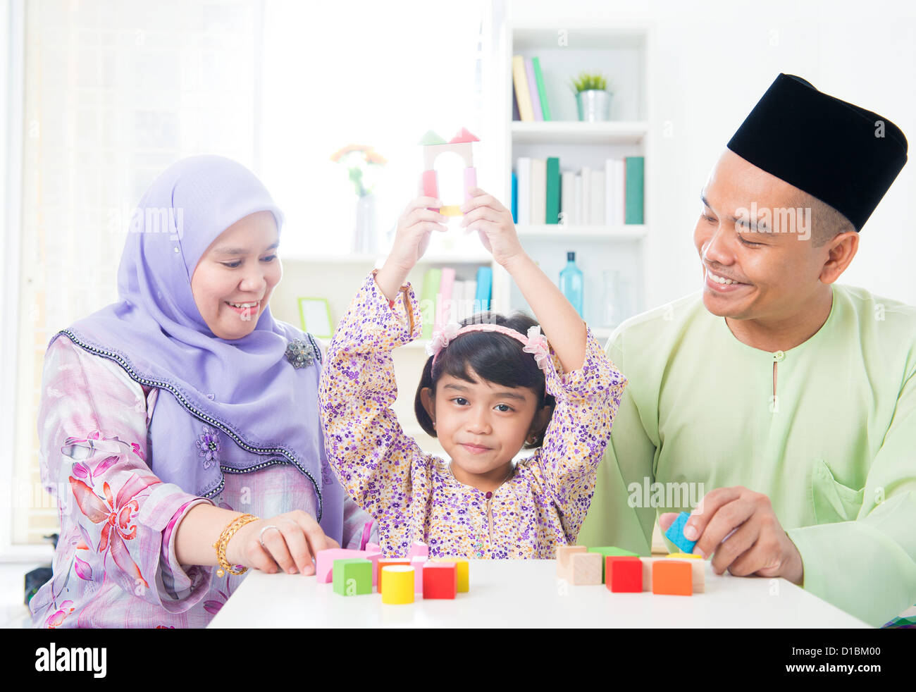 Southeast Asian child achievement. Muslim family playing games Stock ...