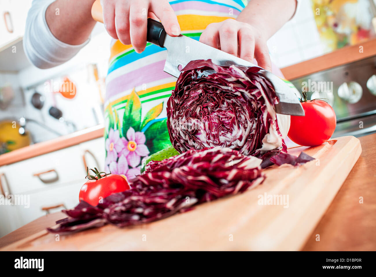 Woman's hands cutting red cabbage, behind fresh vegetables Stock Photo ...