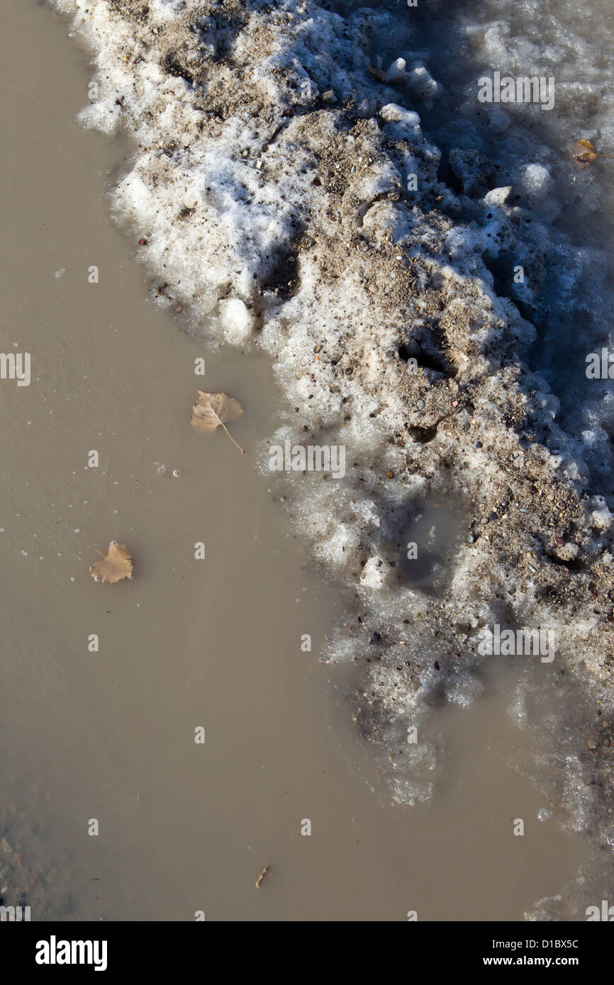 Snow and melted slush on side of road Stock Photo - Alamy