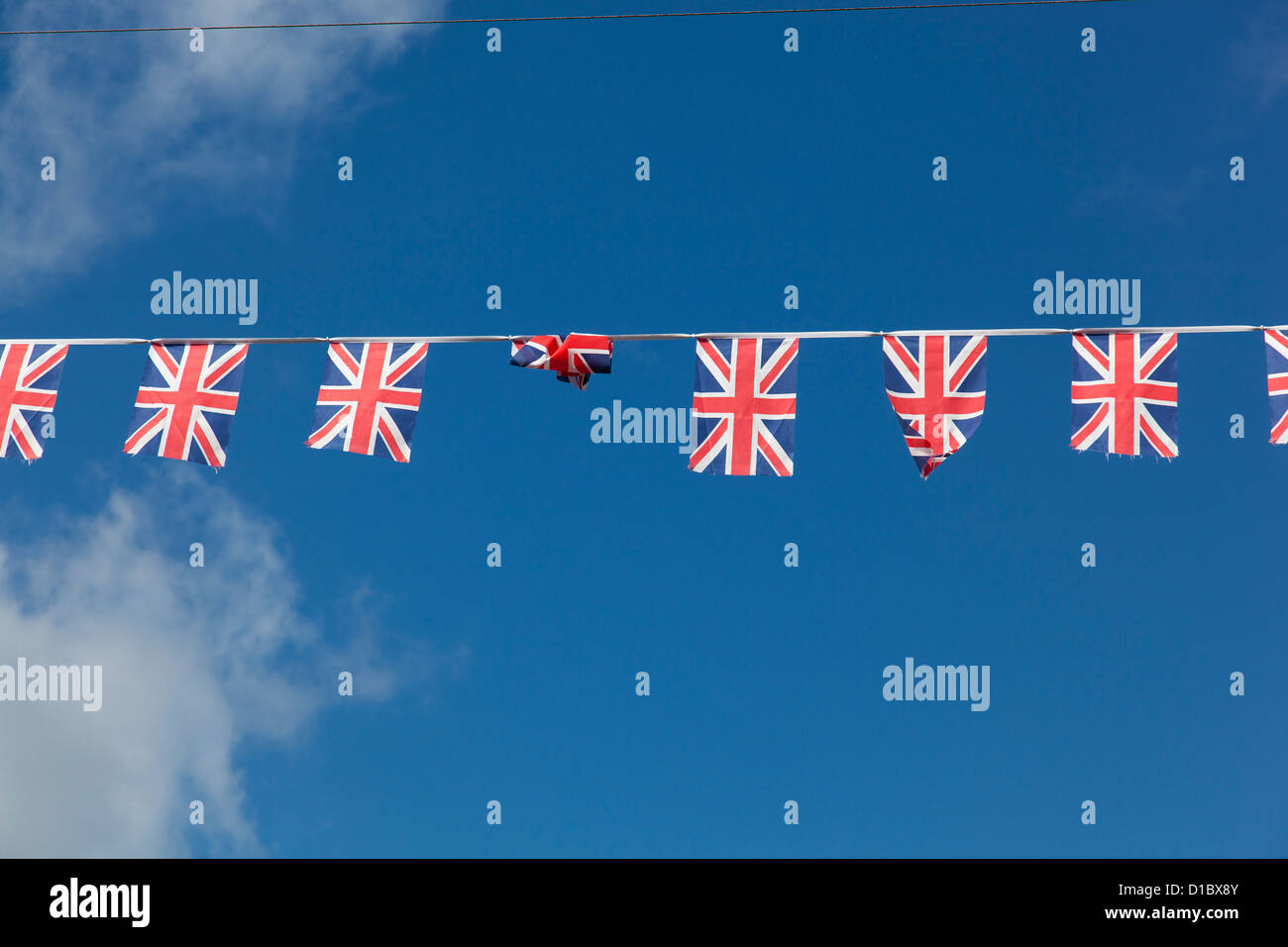 String of Union flags against a blue sky Stock Photo - Alamy