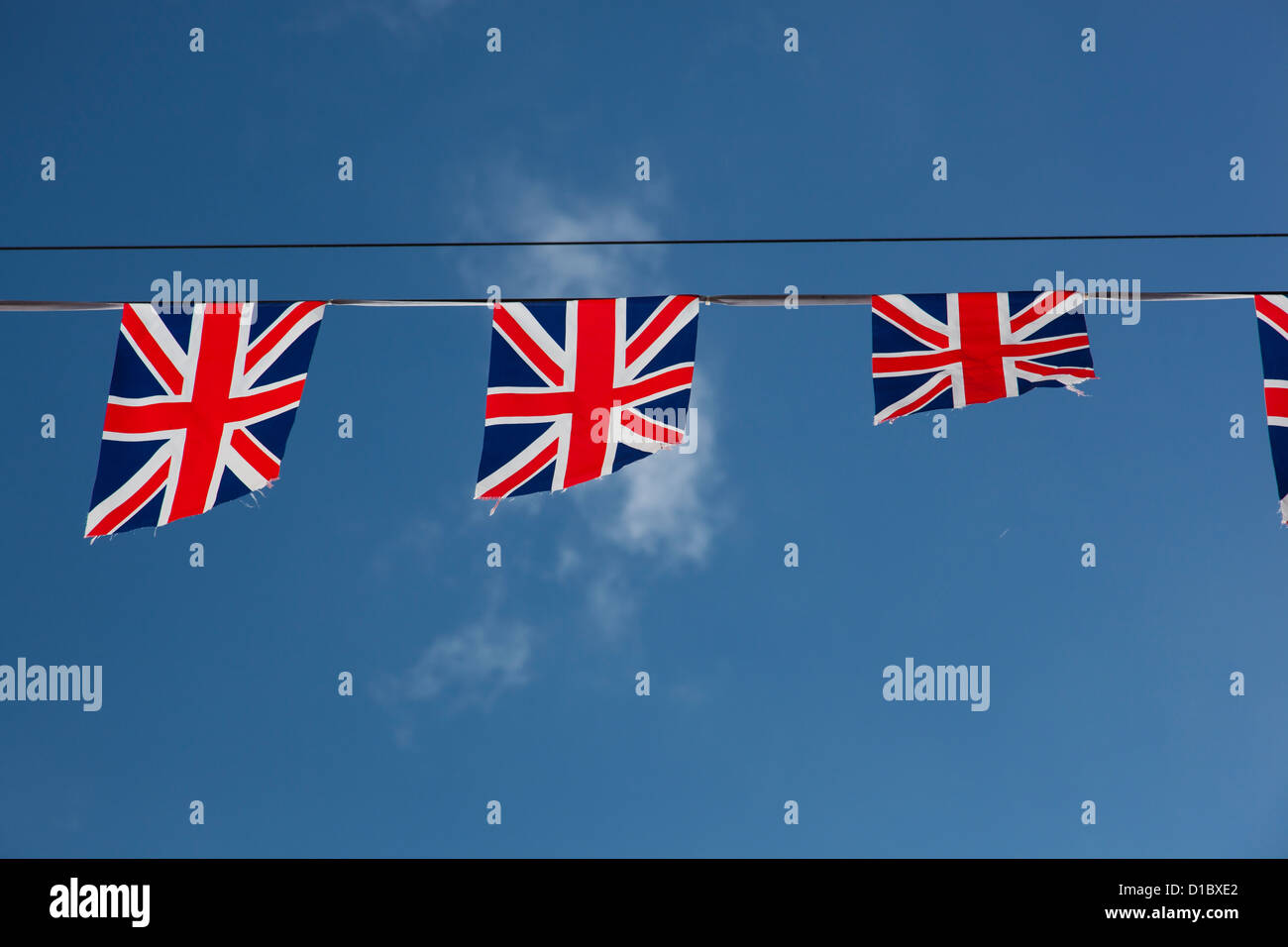 String of Union flags against a blue sky Stock Photo - Alamy