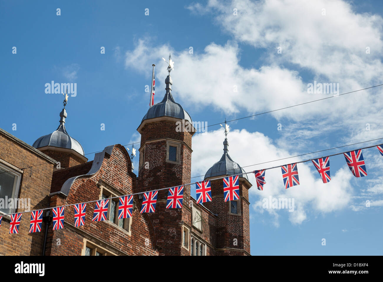 String of Union flags against a blue sky with Abbot's Hospital behind ...