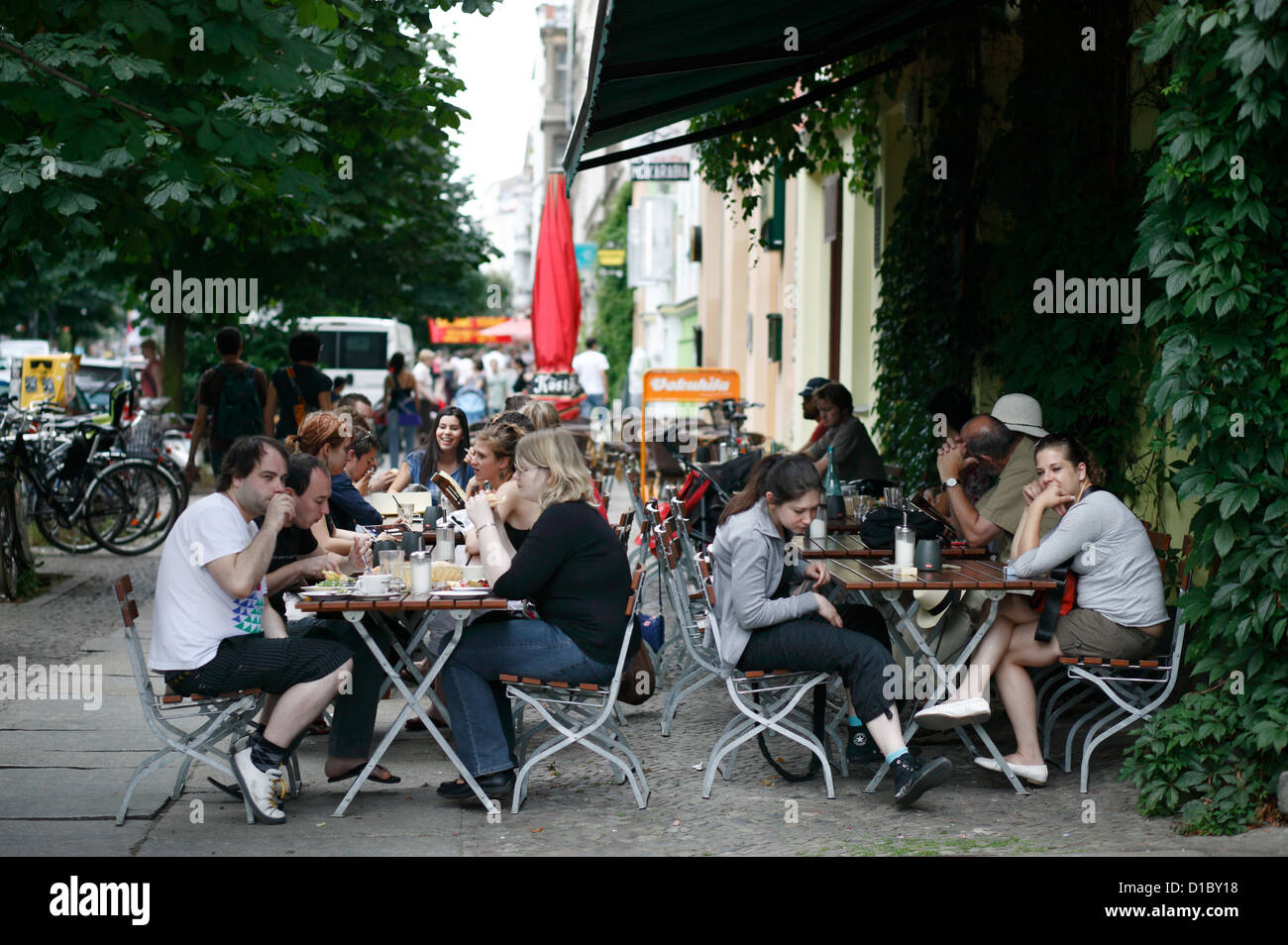 Berlin, Germany, guests sit at a street cafe in Kastanienallee Stock ...