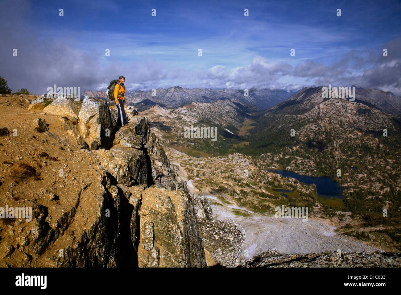 Hiker on the summit of Eagle Cap overlooking the East Lostine River ...