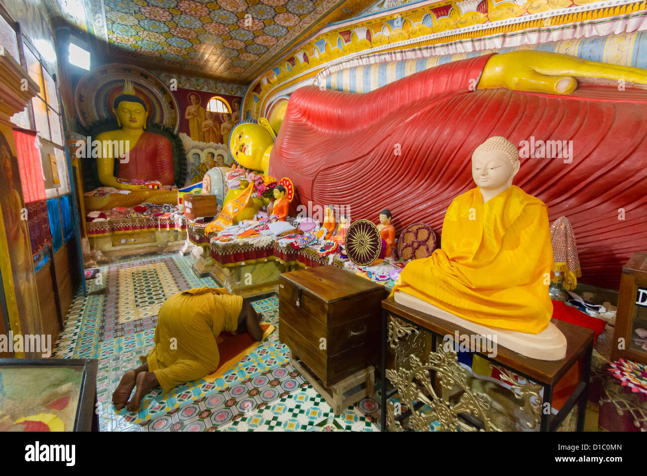 Sri Lankan Buddhist monk performing prostration in front of reclining ...