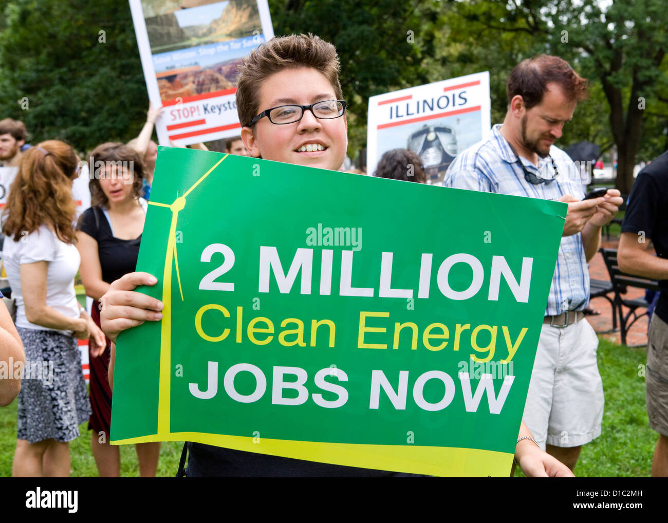Female environmentalist holding sign during protest - Washington, DC ...
