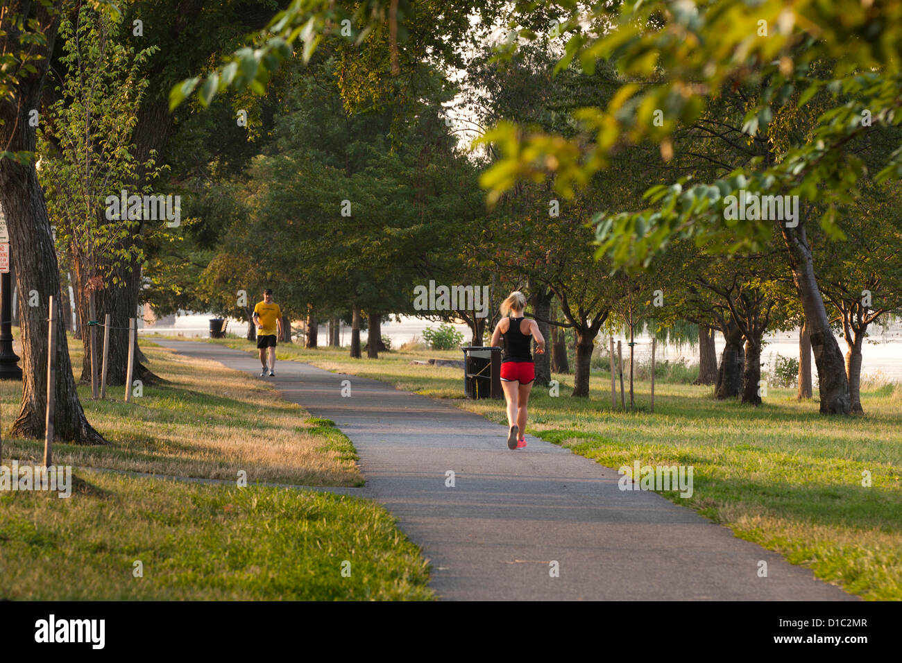 Woman running on path Stock Photo - Alamy