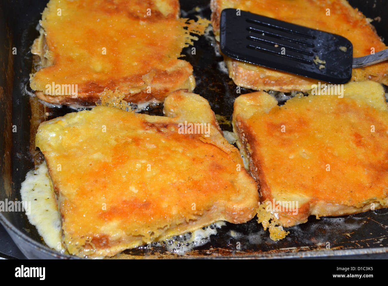 French toast with cheese cooking in frying pan Stock Photo - Alamy