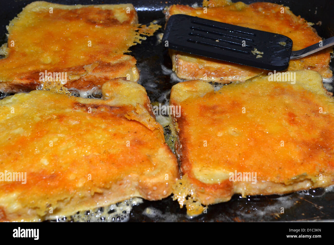 French toast with cheese cooking in frying pan Stock Photo - Alamy