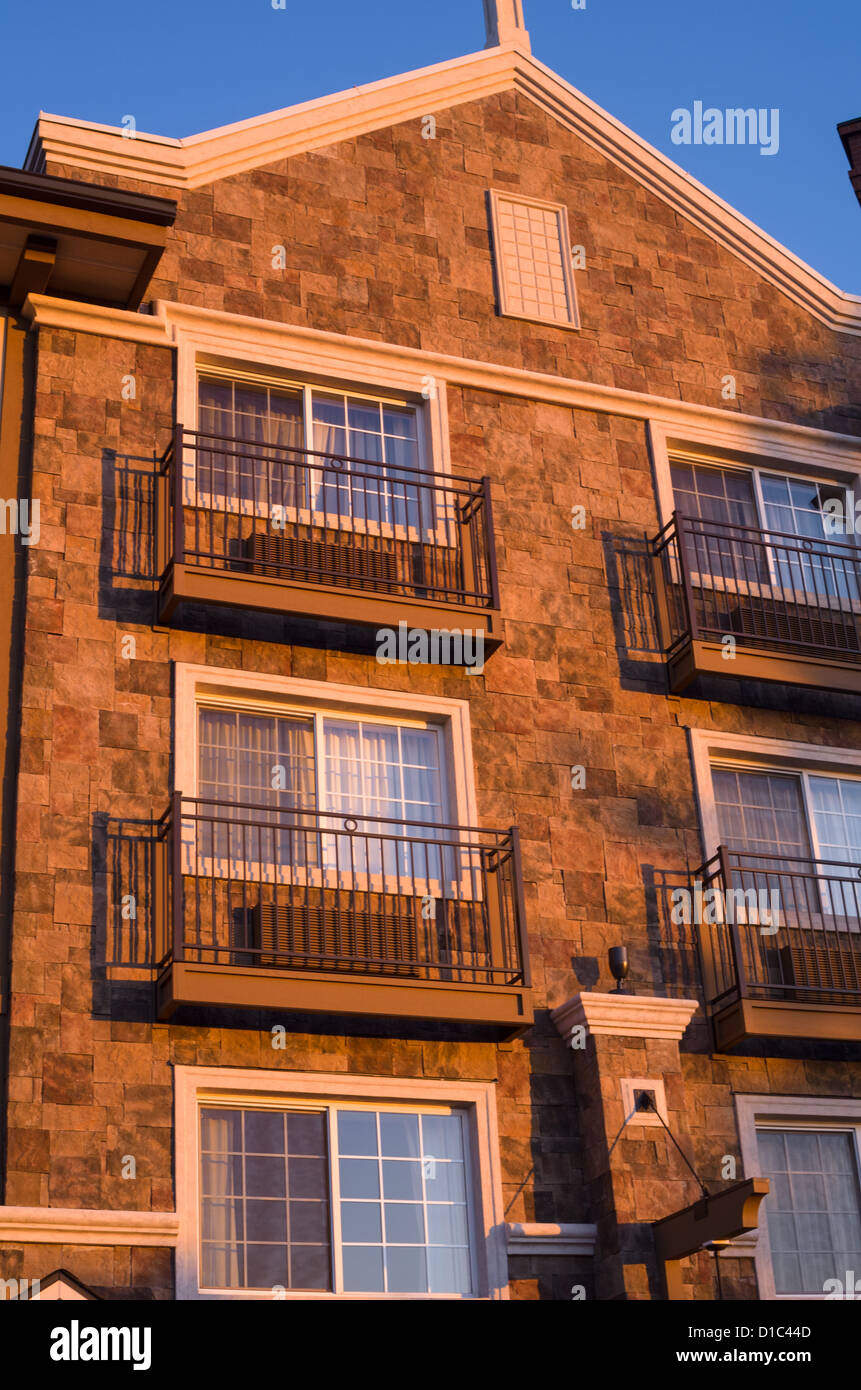 A hotel wall and windows at sunset Stock Photo - Alamy