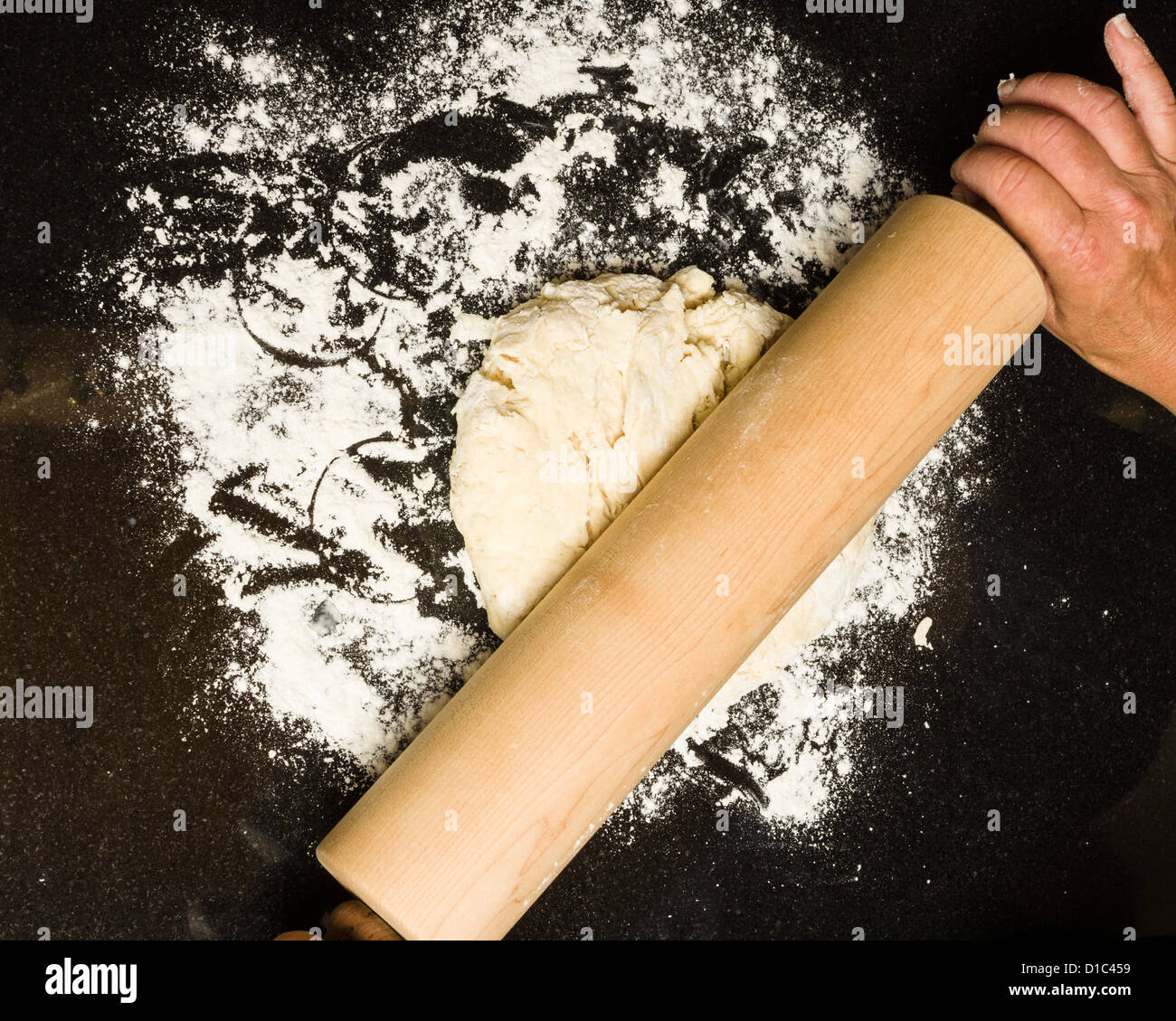 A baker rolling out dough for biscuits Stock Photo - Alamy