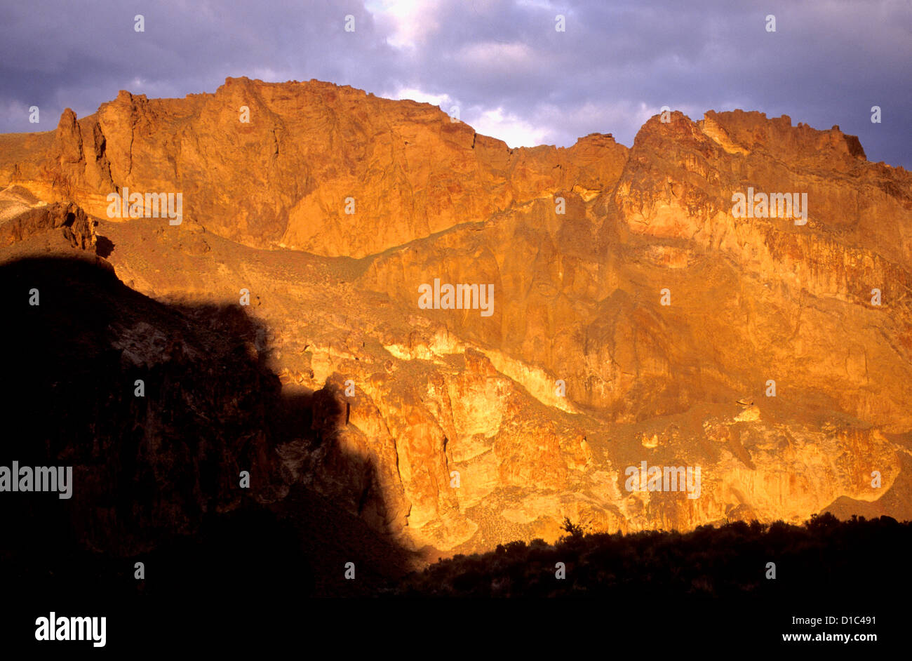 Alpenglow (sunset) reflected off of cliffs above Owyhee River in SE ...