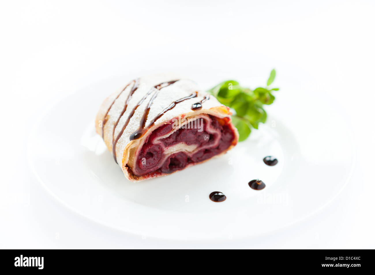 piece of cherry strudel on a white plate, close-up Stock Photo - Alamy