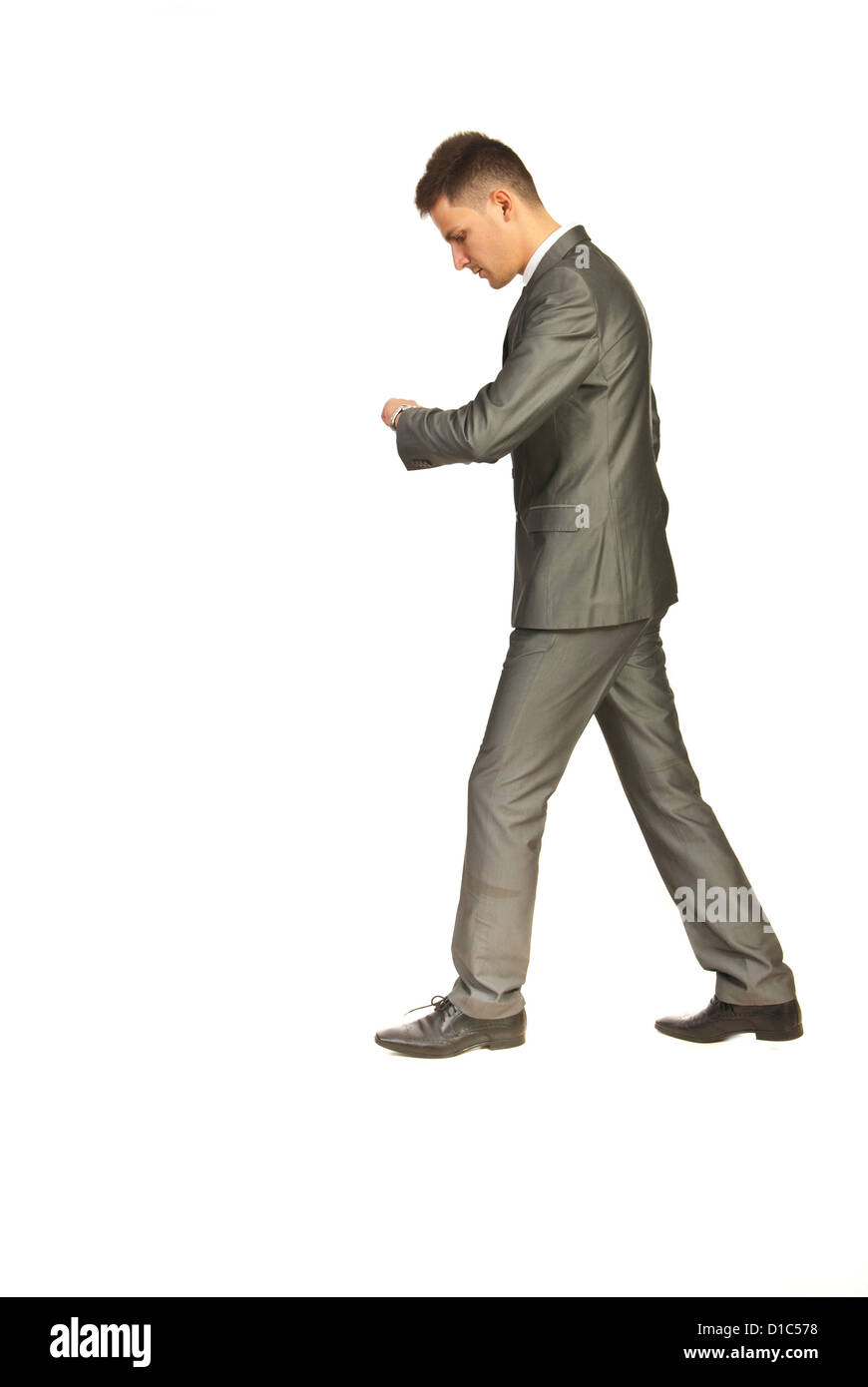 Business man in a hurry walking at work and checking time isolated on ...
