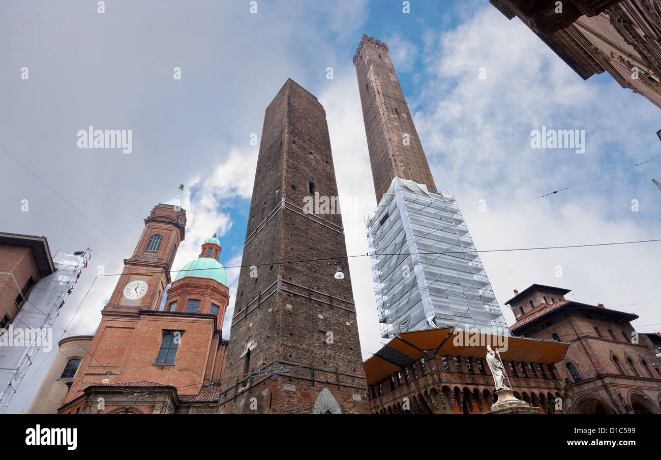 palace and two towers and statue of Saint Petronius under cloudy sky in ...