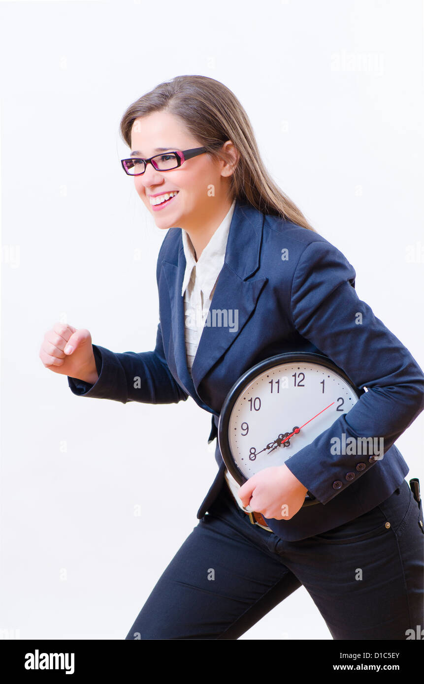 A woman running and holding a clock Stock Photo - Alamy