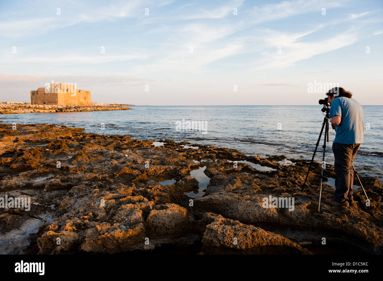 Young man photographing medieval castle at sunset, Paphos, Cyprus Stock ...