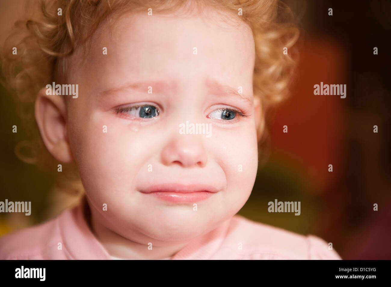 Curly haired blonde baby crying. Face closeup Stock Photo - Alamy
