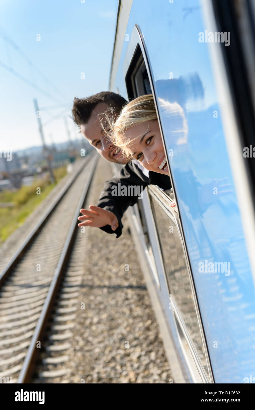 Woman man heads out the train window smiling travel commuting Stock ...