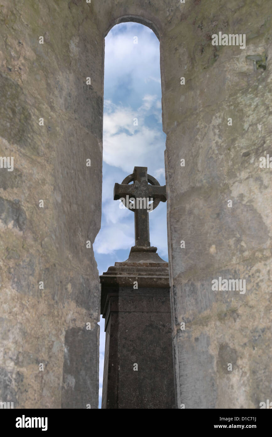 celtic cross through an old church arch window Stock Photo - Alamy