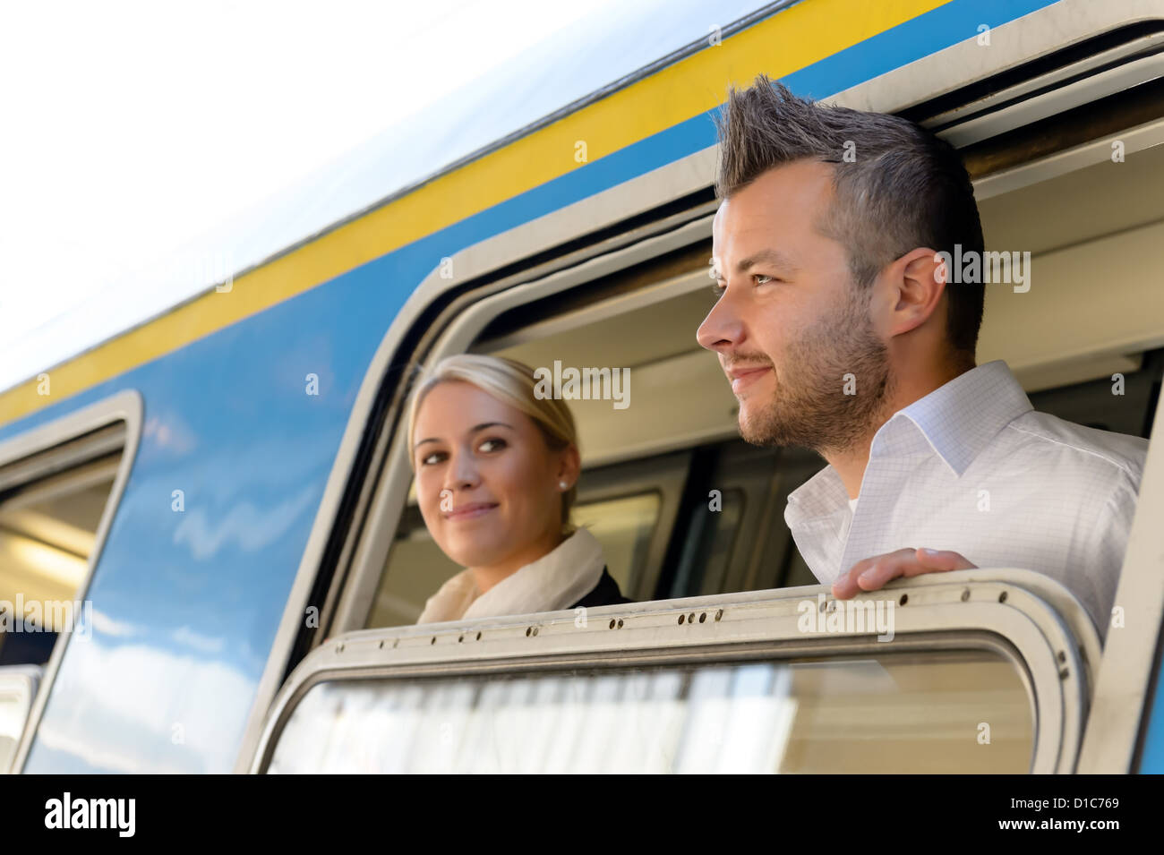 Man and woman looking out train window smiling commuters journey Stock ...