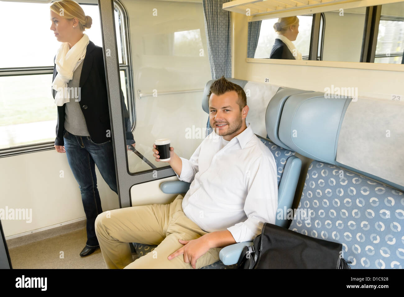 Man sitting in train woman on hallway coffee commuters smiling Stock ...