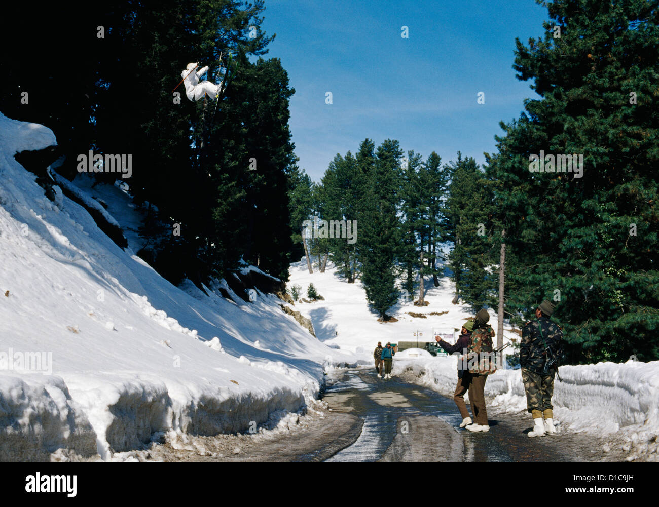 Skiing in India, Skier jumping over the road at a military checkpoint ...