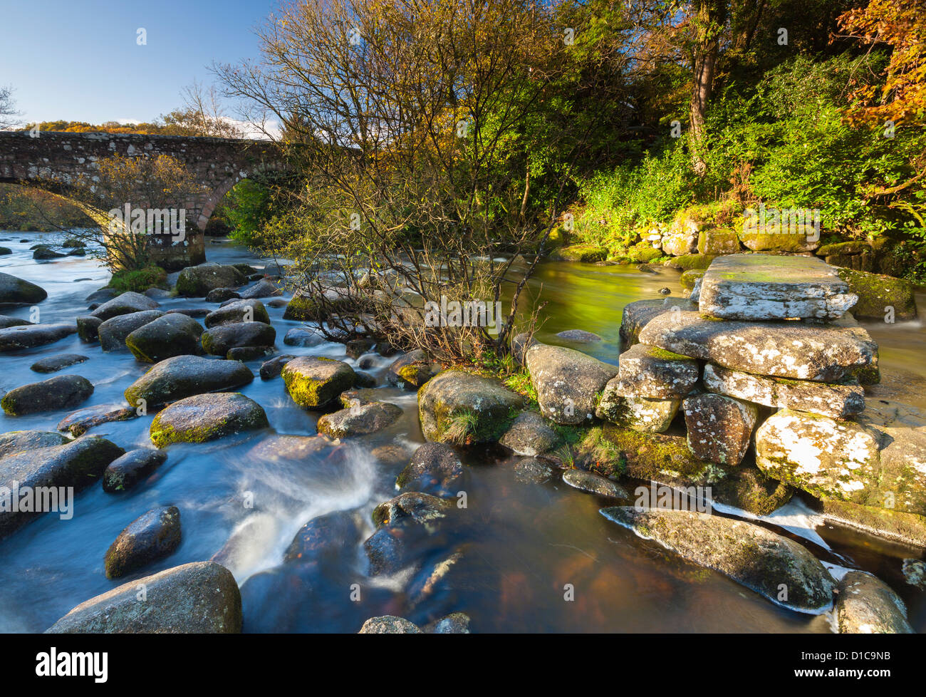 Dartmeet Bridge over the East Dart River flowing through woodland in ...