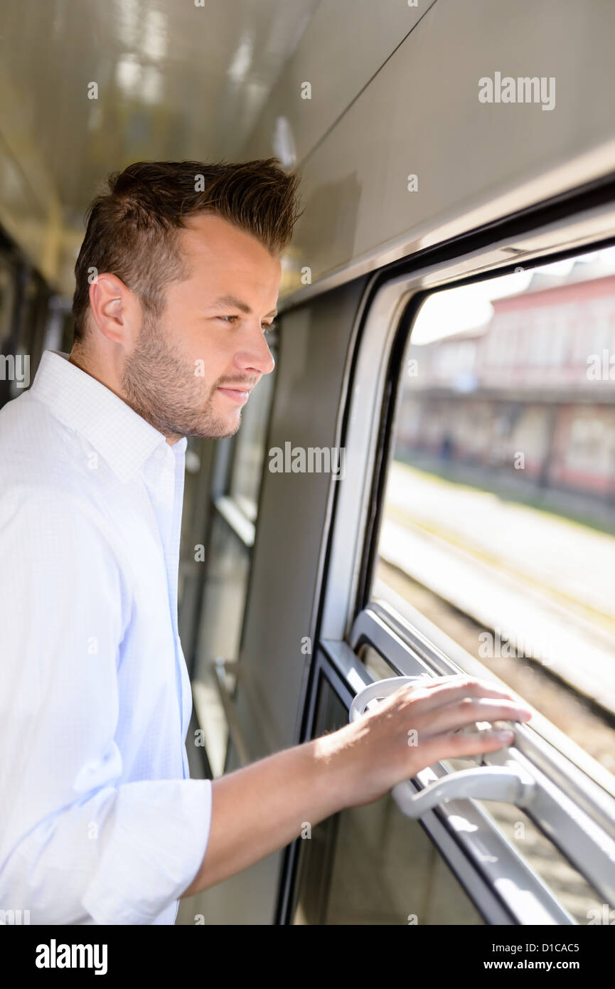 Man looking out the train window smiling commuter journey ride Stock ...