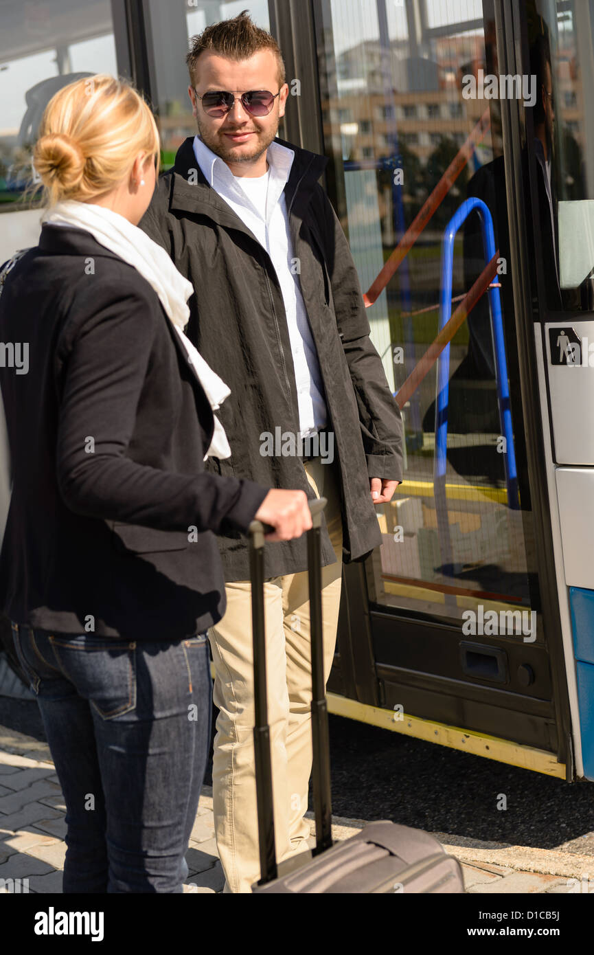 Woman and man talking in bus station smiling commuters journey Stock ...