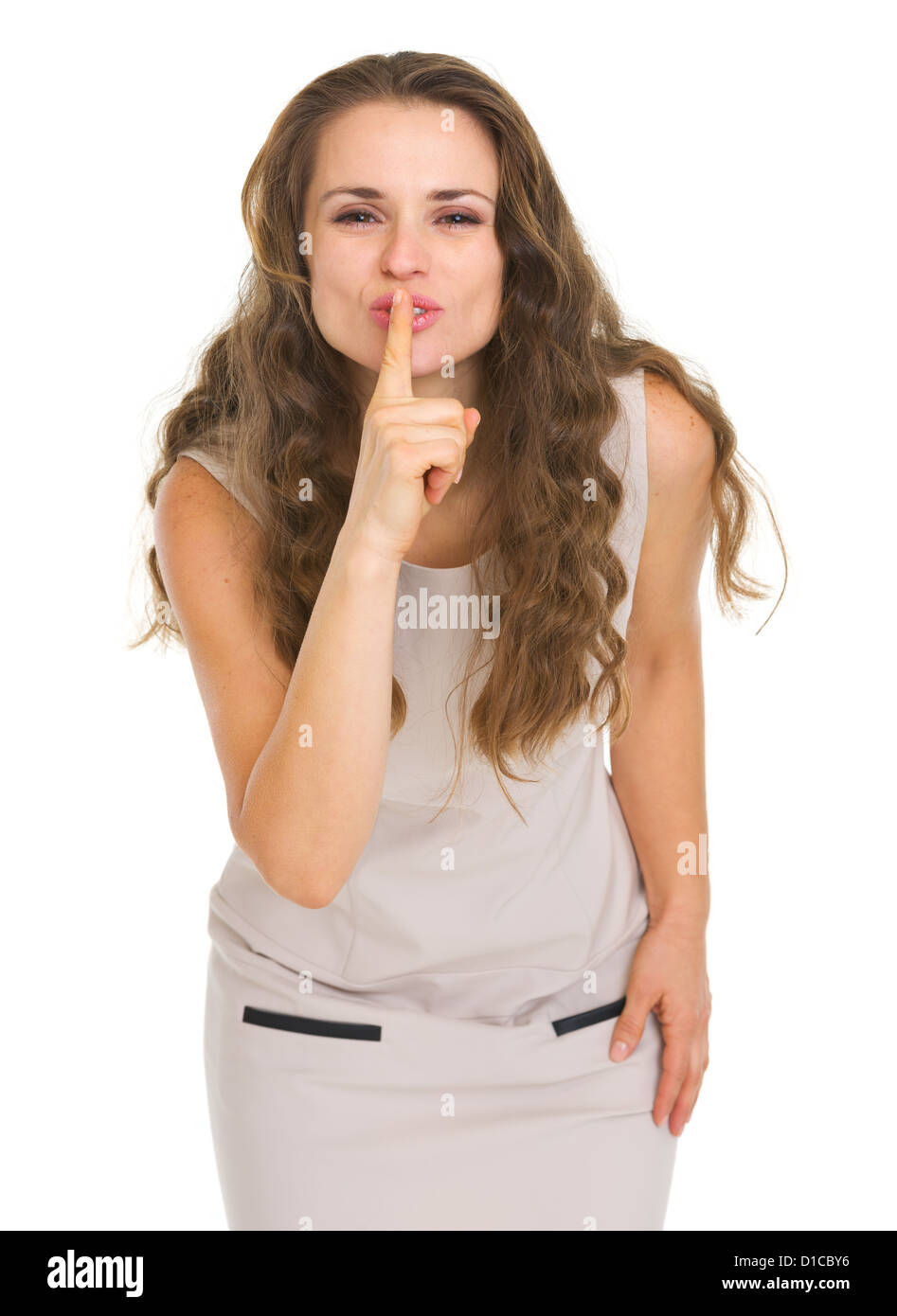 Young woman in dress showing shh.. gesture Stock Photo - Alamy