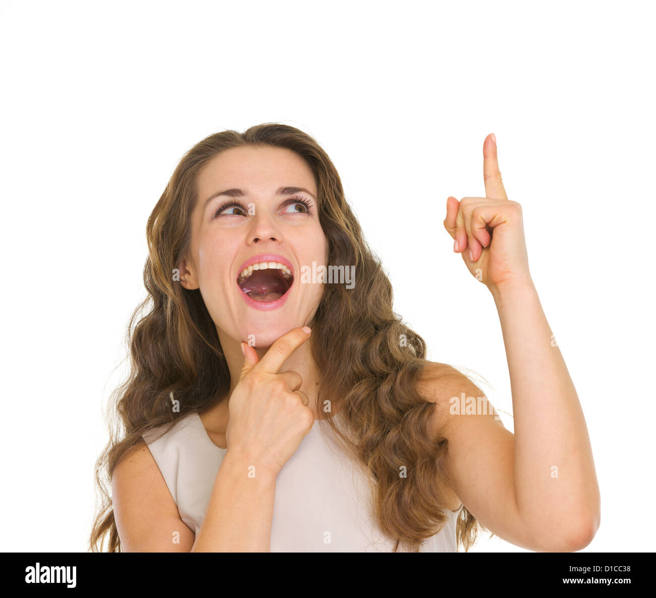 Thoughtful young woman pointing up Stock Photo - Alamy