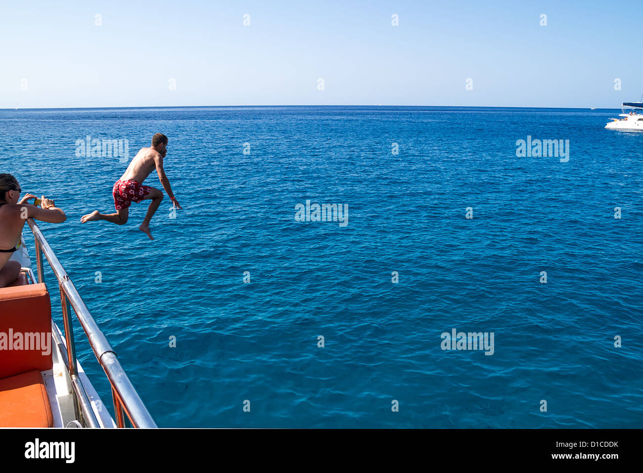 Young man diving into the sea Stock Photo - Alamy