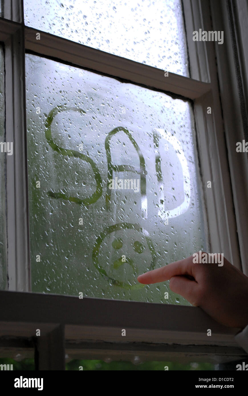 Lonely child writing SAD in condensation on a window Stock Photo - Alamy