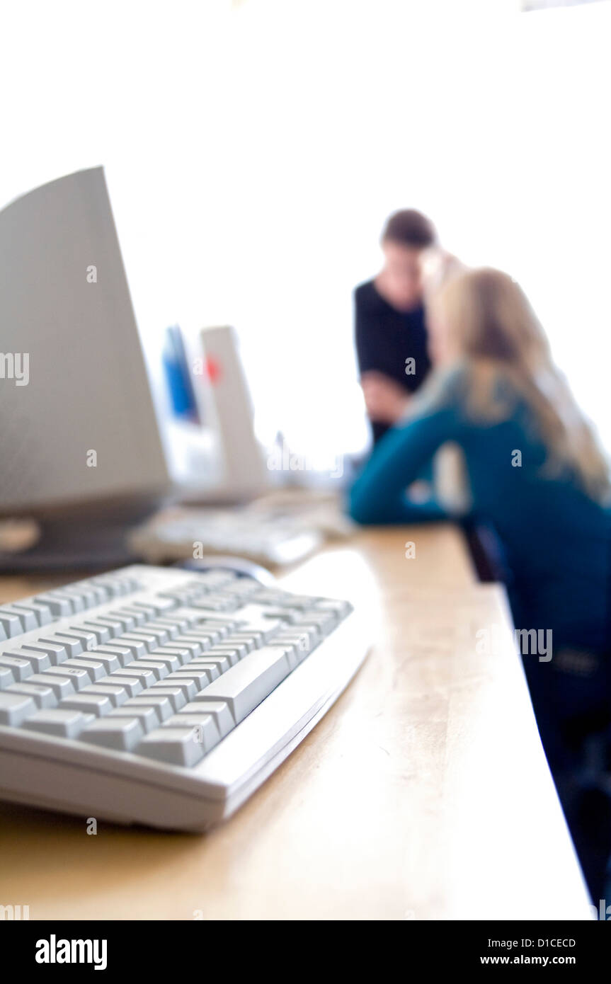 Three young people at their computer workplace Stock Photo - Alamy