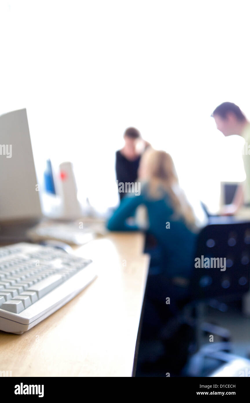 Three young people at their computer workplace Stock Photo - Alamy