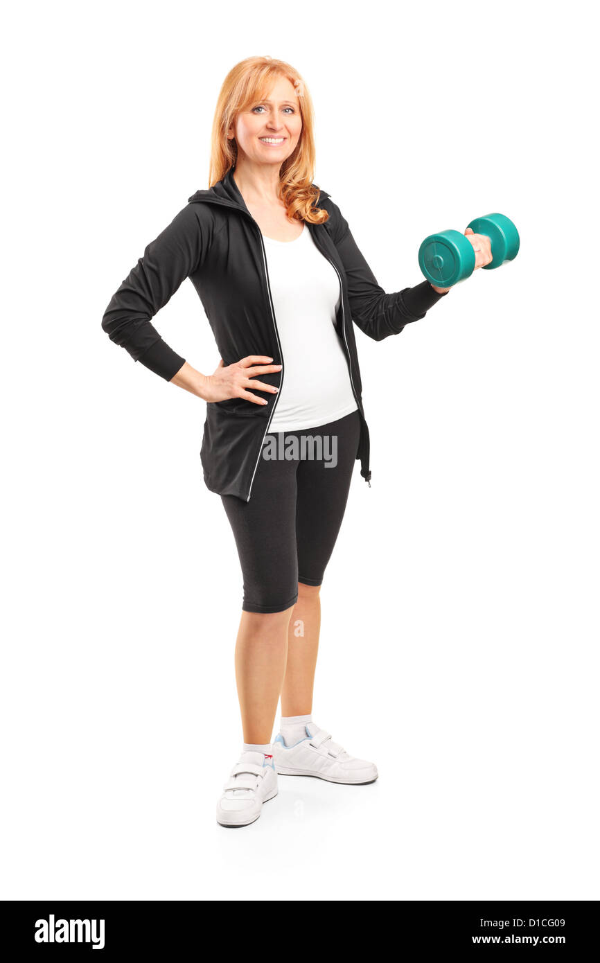 Full length portrait of a mature woman lifting up a dumbbell isolated ...