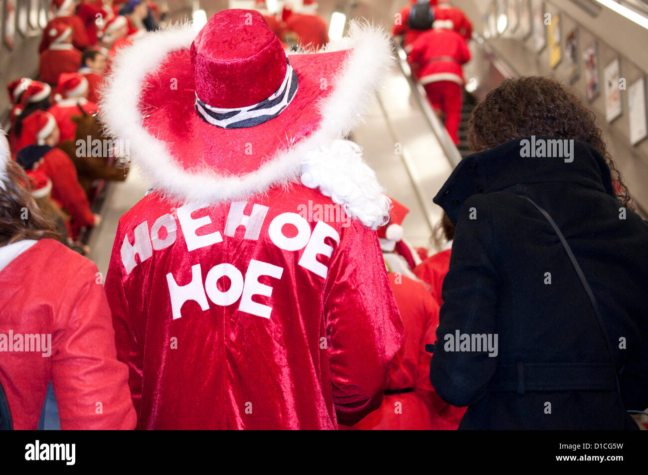 15 December 2012 London UK. Fancy dressed revellers ride an escalator ...