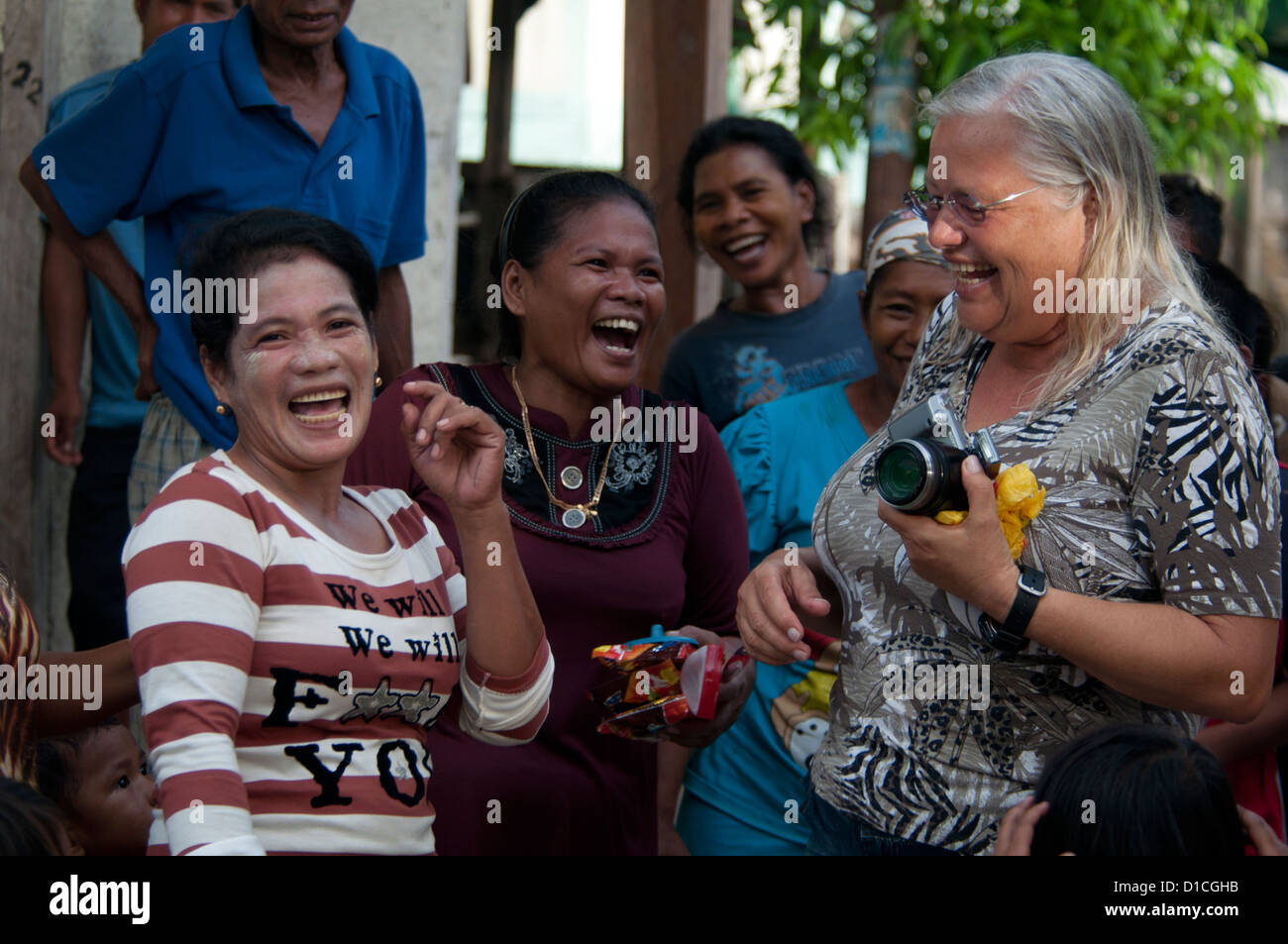 A tourist takes photos of and interacts with the local women of Pau ...